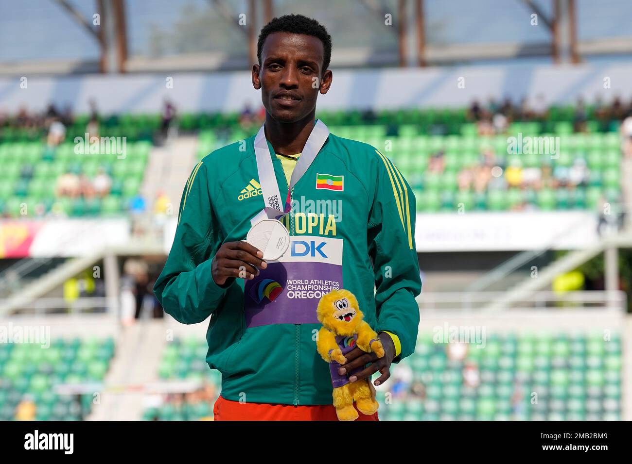 Silver medalist Lamecha Girma, of Ethiopia, left, stands during a medal ...