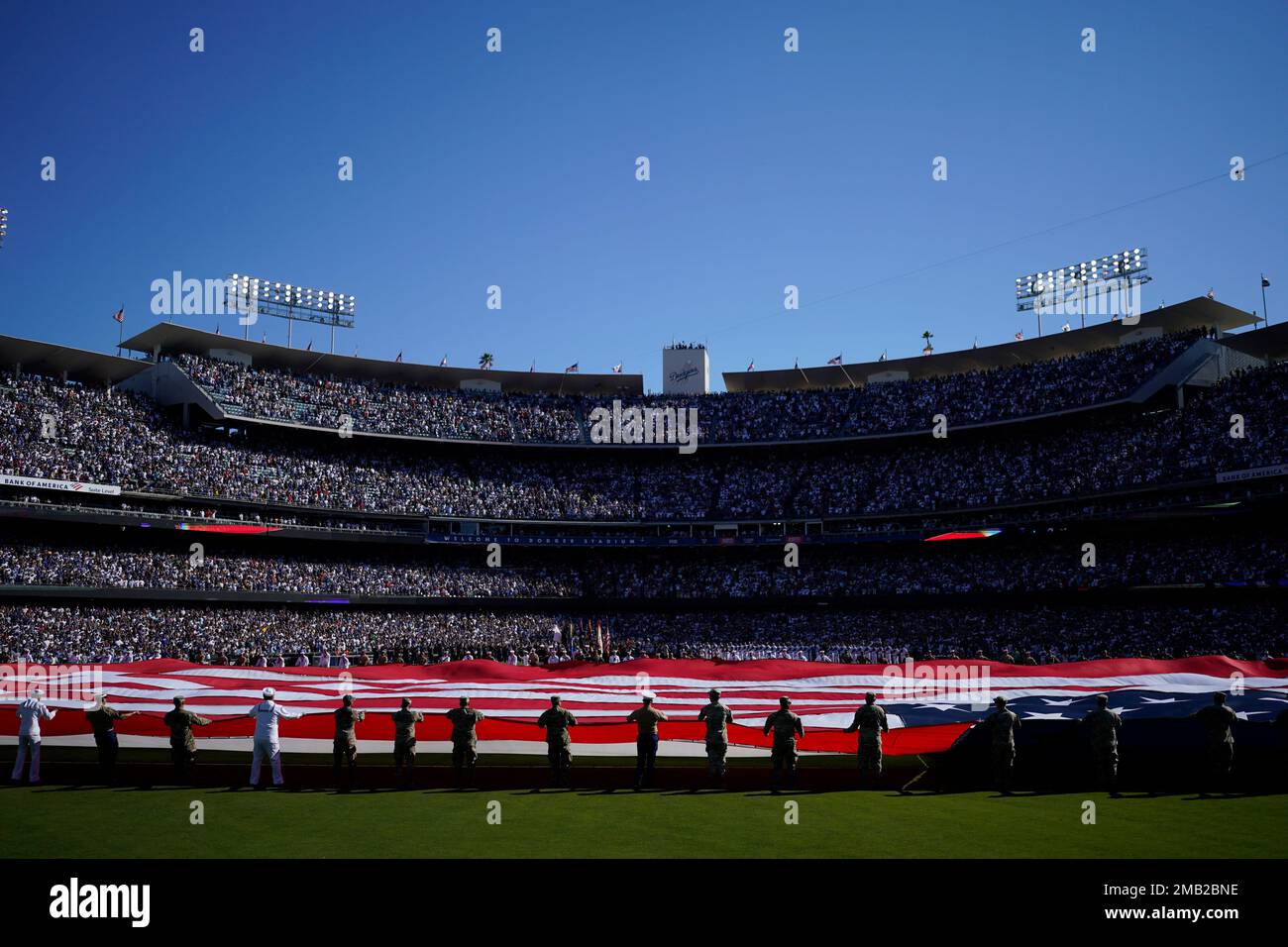 Military personnel hold a U.S. flag on the field before the MLB All ...