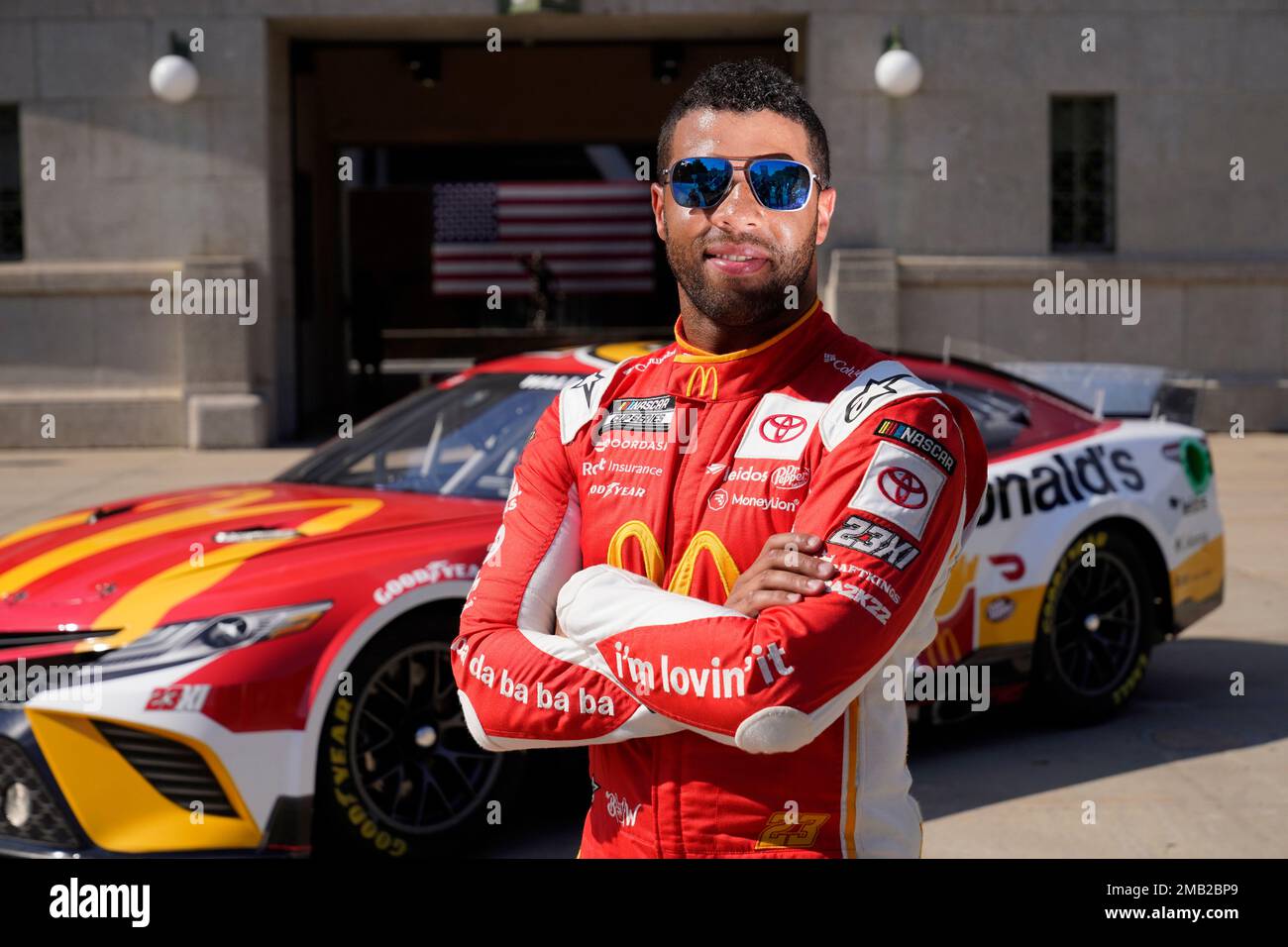 NASCAR driver Bubba Wallace poses for photographers with his #23 car ...