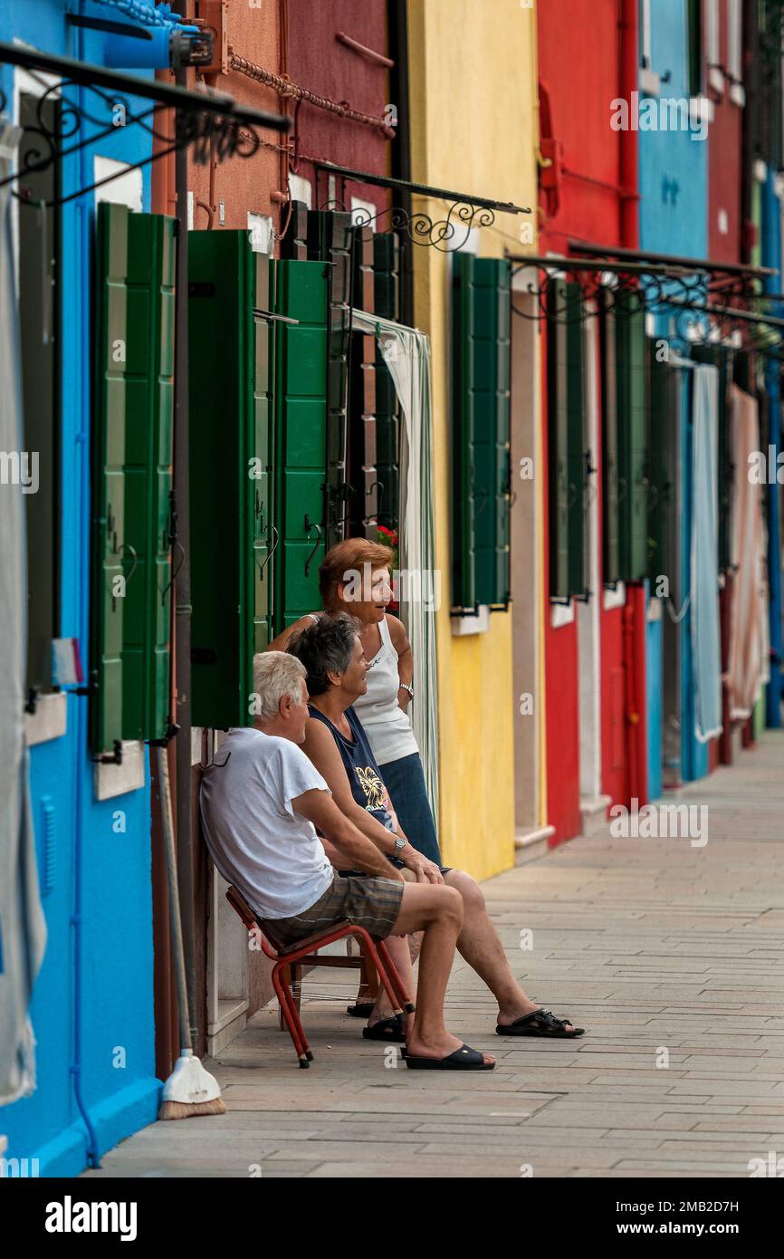 People on the doorstep of the island of Burano, Venice, Veneto, Italy ...
