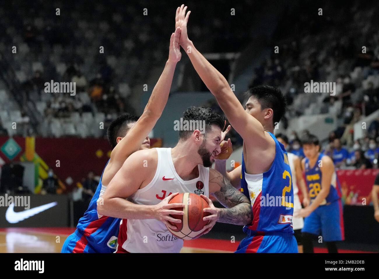 Japan's Luke Evans, center, attempts to drive around Philippine's ...