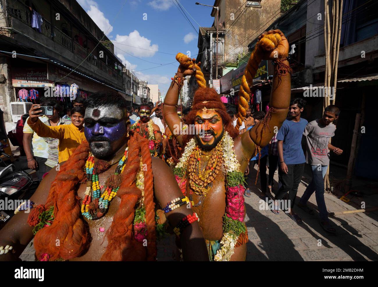 People dressed as Pothuraju, a mythical character, dances near the ...