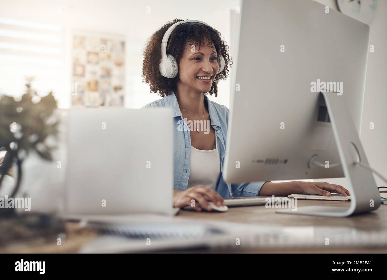 Working on my blog. an attractive young woman sitting alone at home and ...