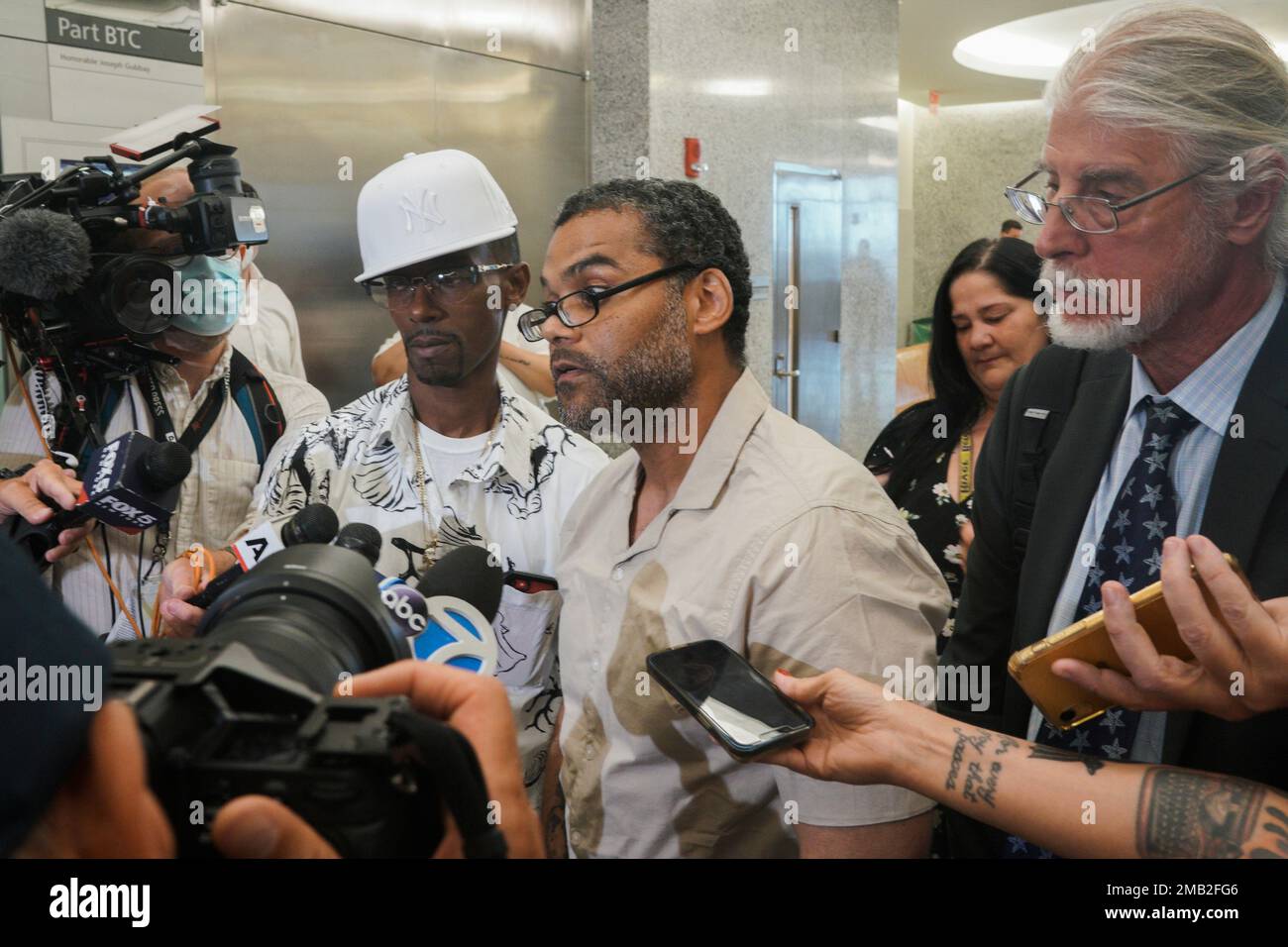 Attorney Ron Kuby, far right, listens as his clients Vincent Ellerbe ...