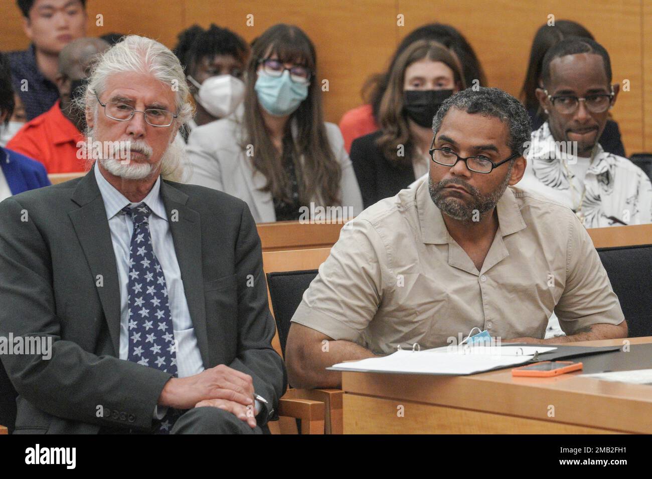 Attorney Ron Kuby, far left, listens with his clients Vincent Ellerbe ...
