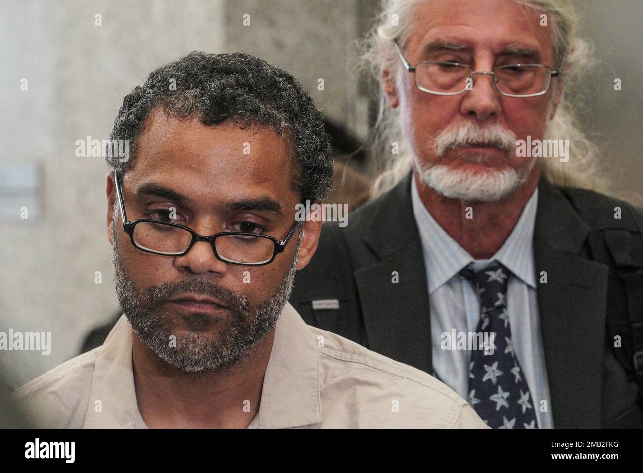 Attorney Ron Kuby, right, listens as his client Thomas Malik talks with ...