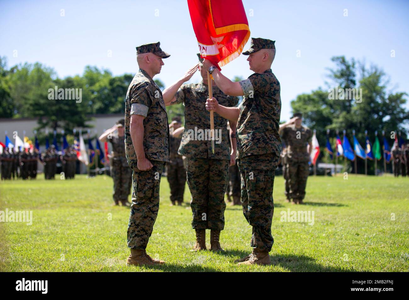 U.S. Marine Corps Lt. Col. Erik C. Quist, right, outgoing commanding officer, passes the ...