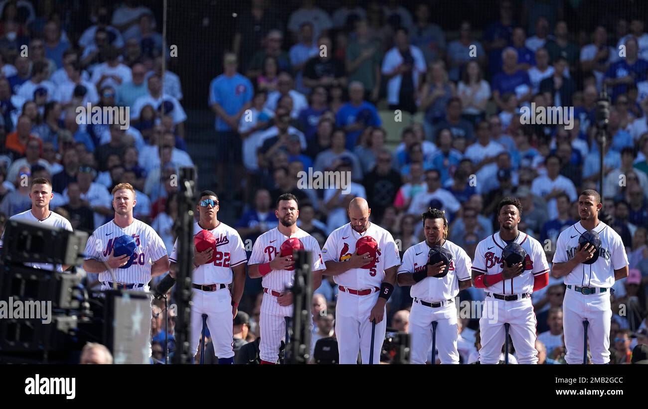 Participants listen to the national anthem during the MLB All-Star ...