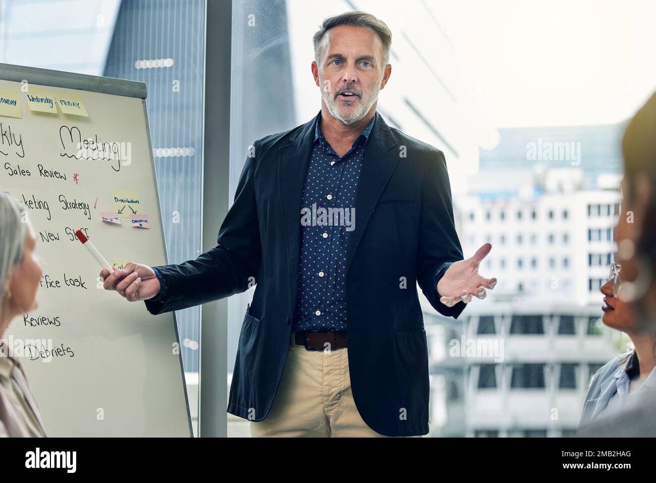 If we change the marketing itll work. a businessman giving his staff a ...