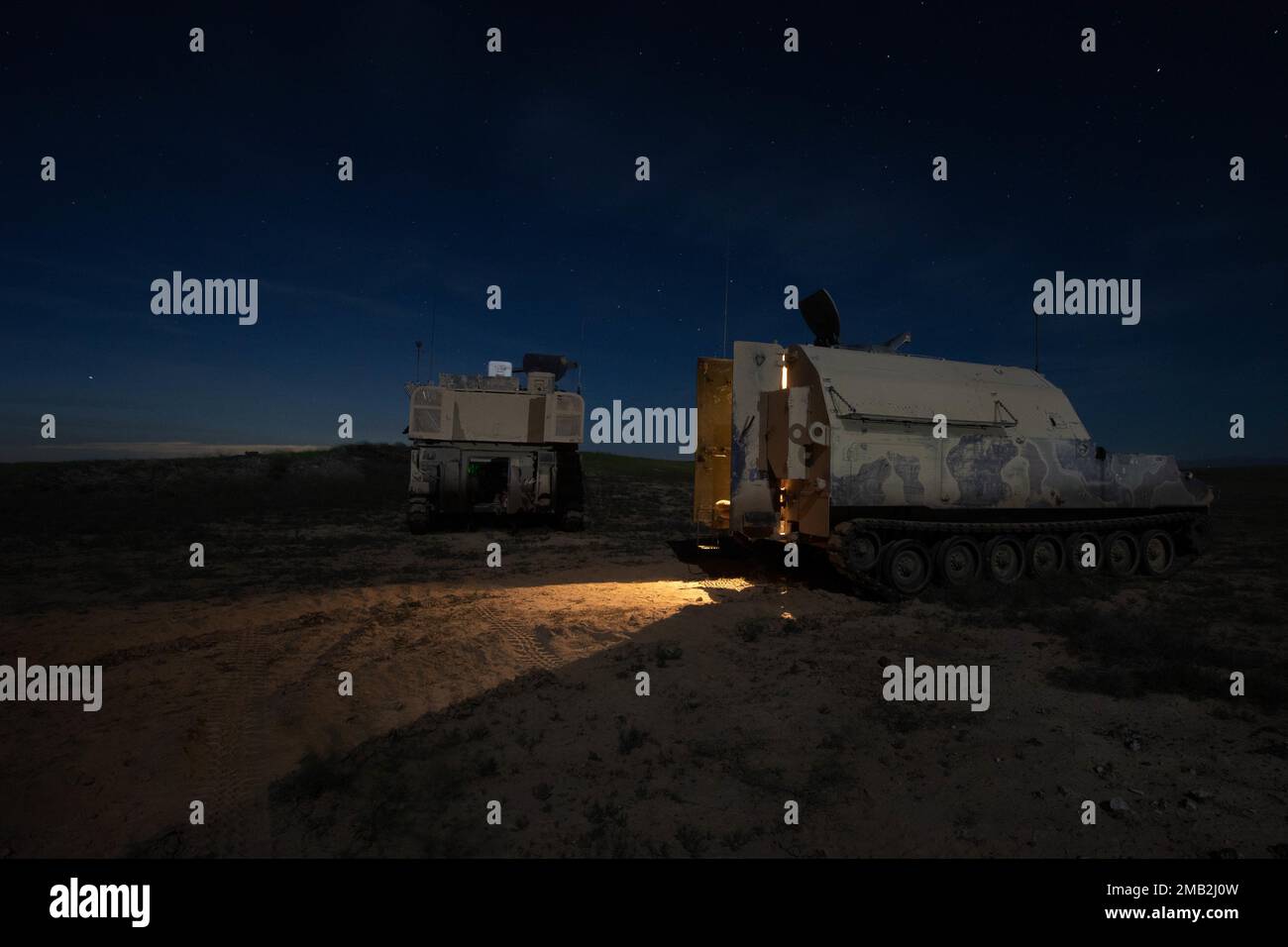 Light spills out from a M992 Field Artillery Ammunition Support Vehicle ...