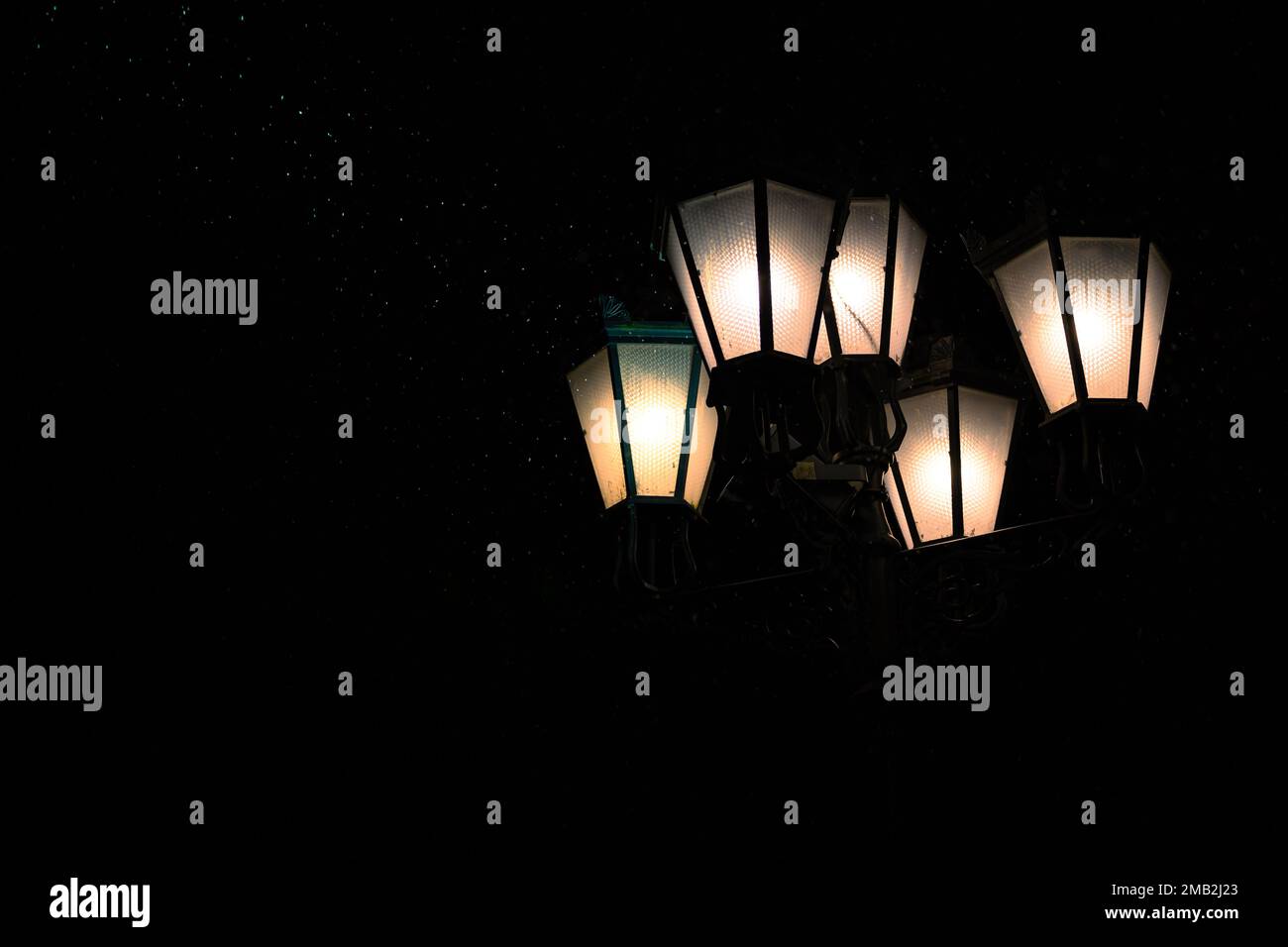 Old, stylish street lamps at night. A streak of light with illuminated ...