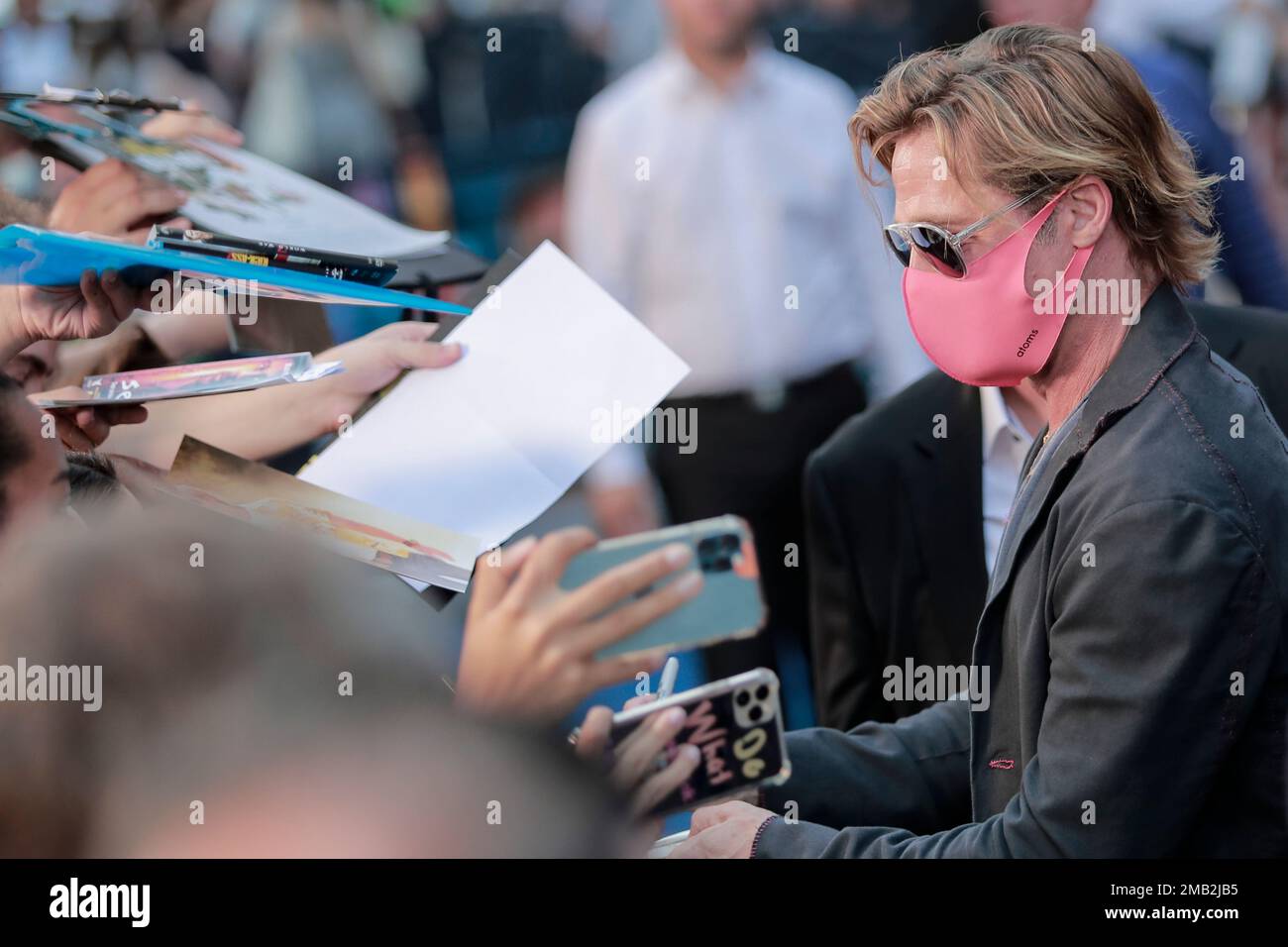 Brad Pitt signs autographs as he arrives for the premiere of the film ...