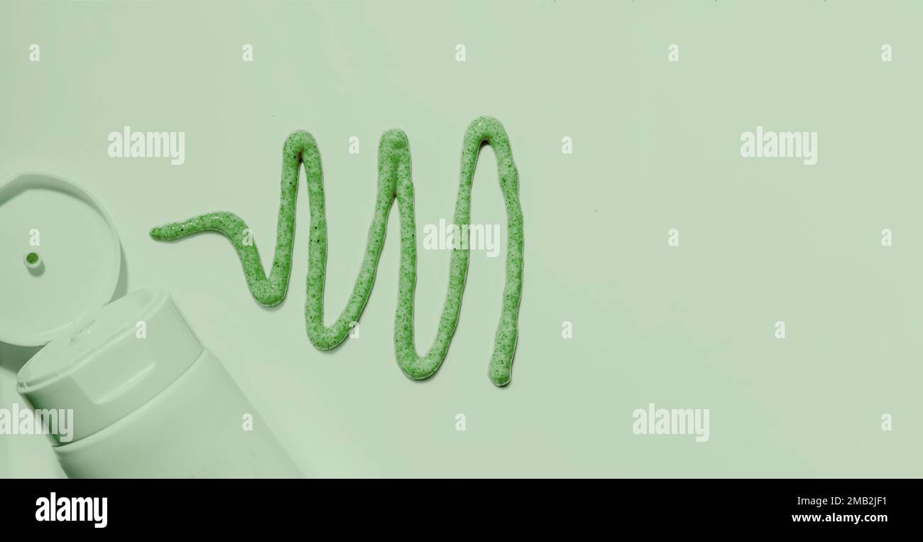 Creamy natural scrub on green background. Mock up. Liquid cosmetic ...