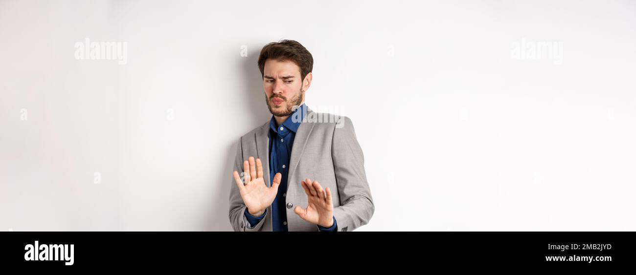 Stay away. Reluctant businessman step back with concerned disgusted ...