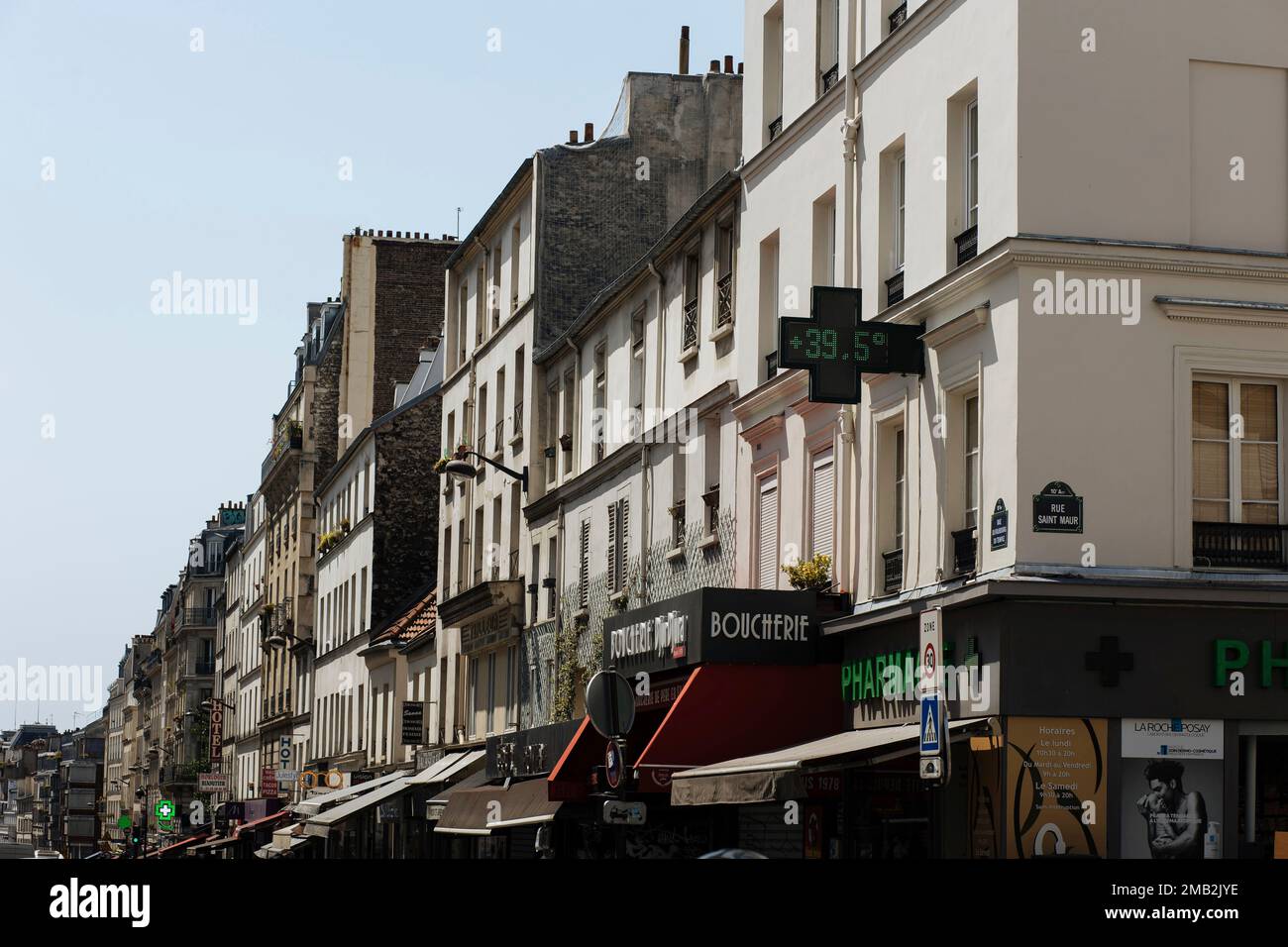 A sign outside a drugstore shows the temperature of 39,5 degrees ...