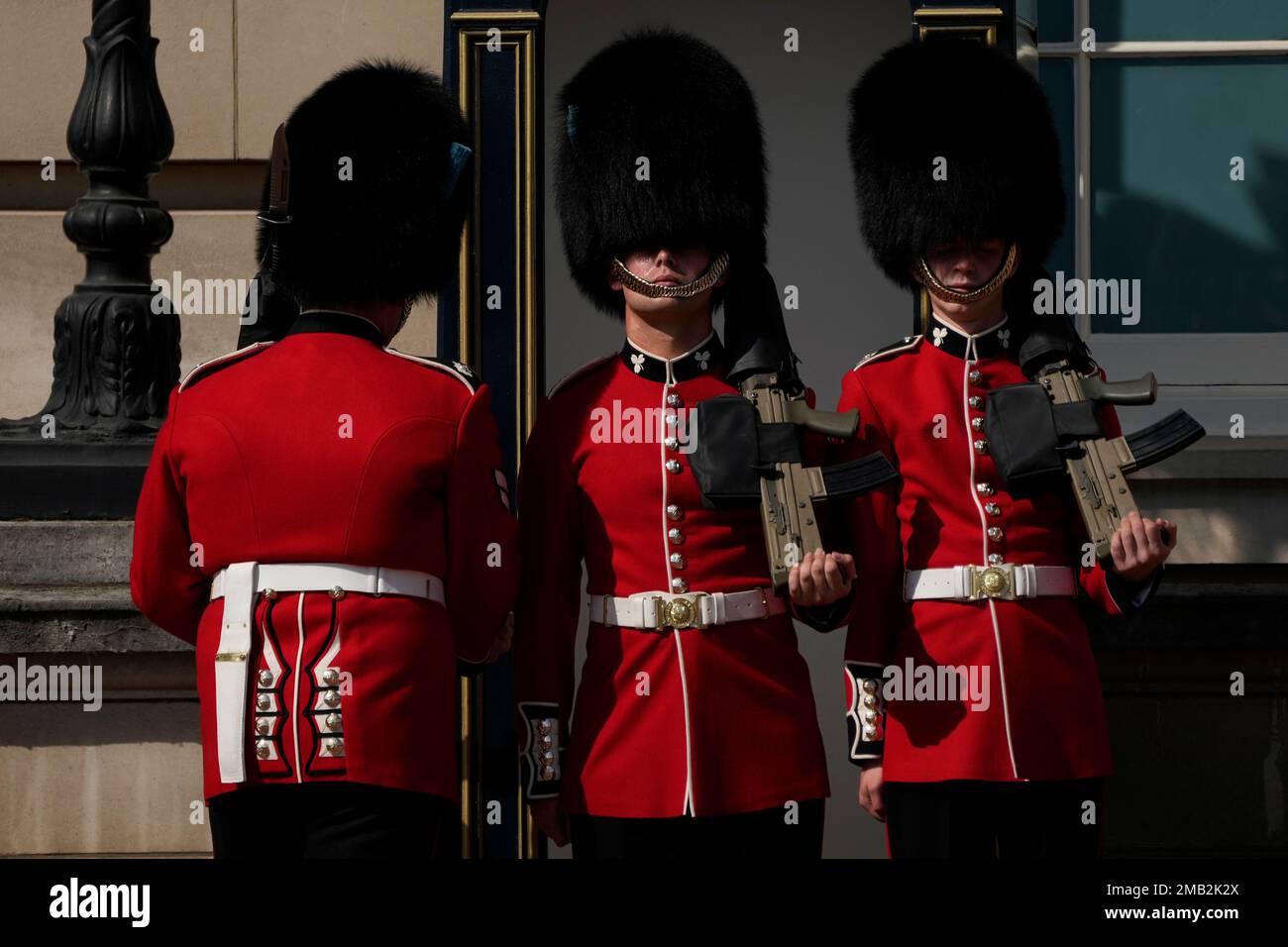 A British soldier, center, wearing a traditional bearskin hat, is ...
