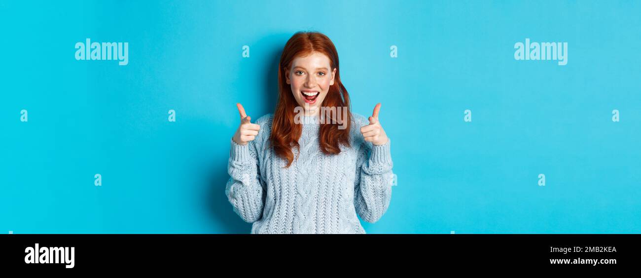 Cheerful teenage girl showing approval, make thumbs up and agree ...