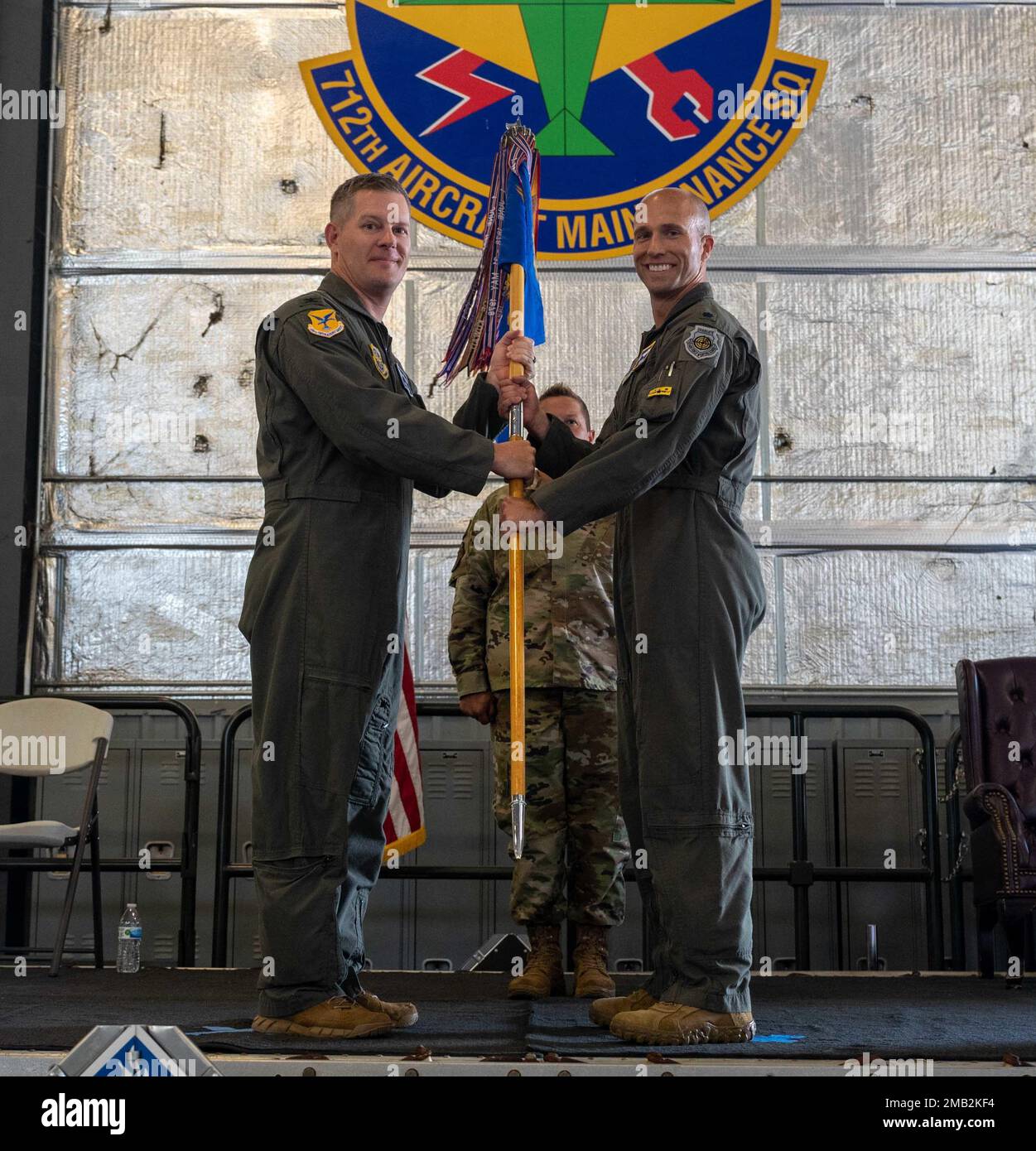 Col. Scott Raleigh, left, 436th Operations Group commander, passes the ...