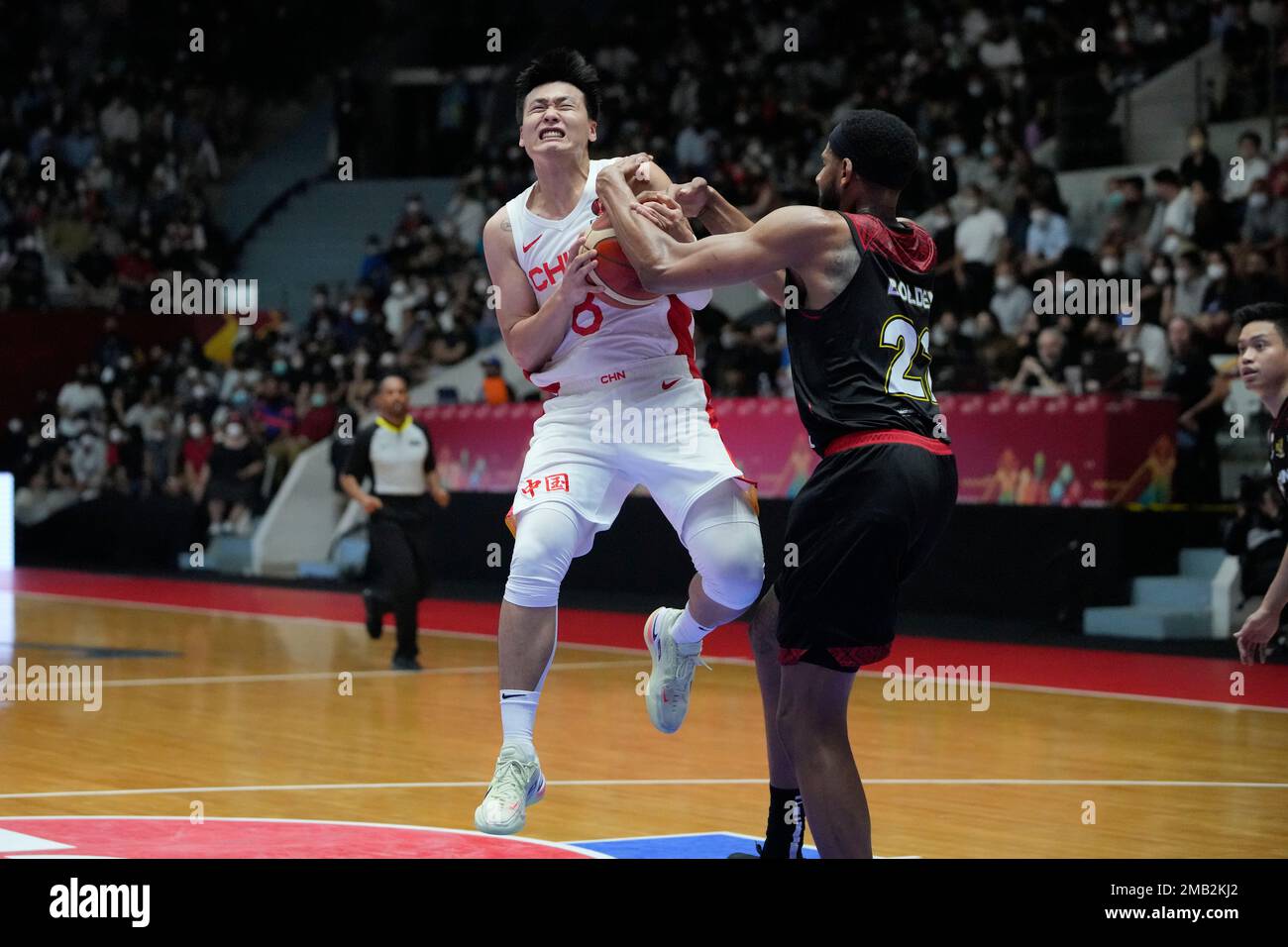 China's Zhao Rui, center, reacts as he is fouled by Indonesia's Marques ...