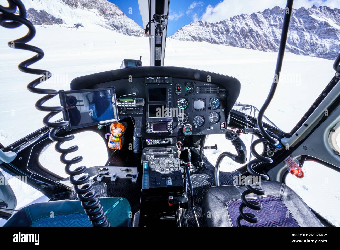 Helicopter cockpit inside. Close up of instruments, look out to snow ...