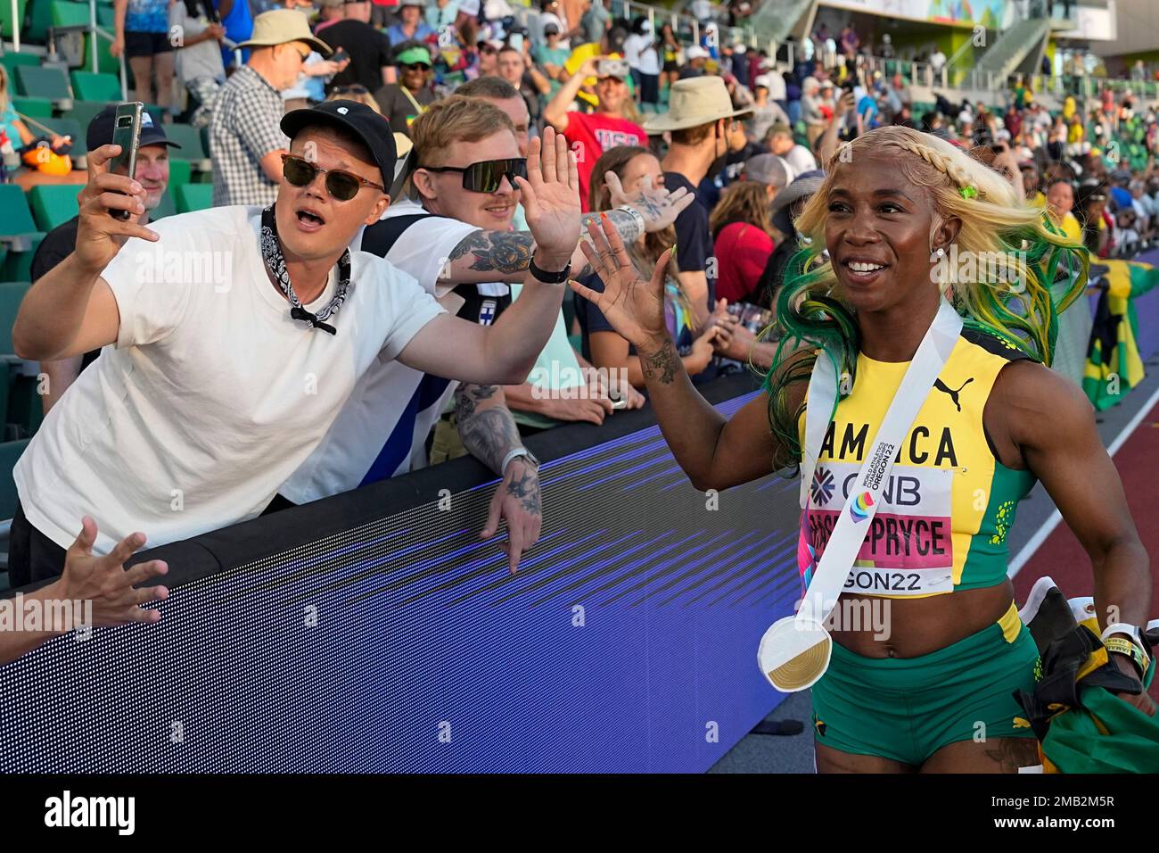 Shelly-Ann Fraser-Pryce, of Jamaica, reacts after winning Gold in the ...