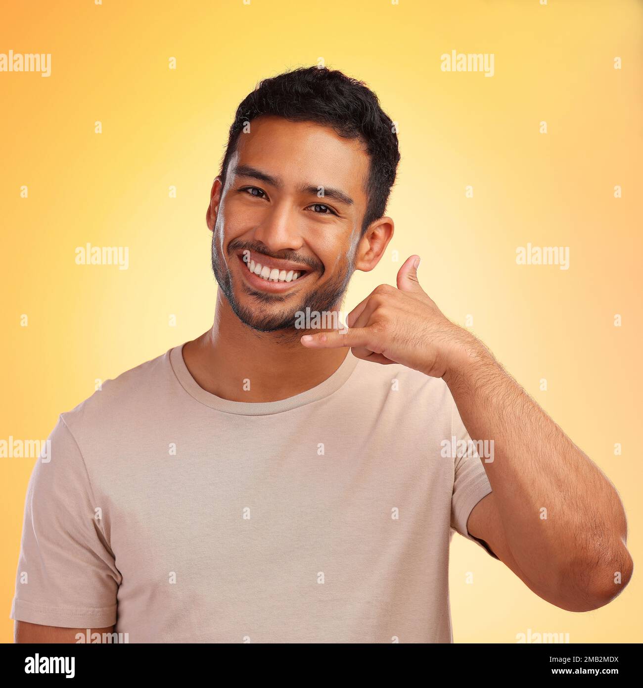 Portrait, call me hands and man in studio isolated on a yellow ...