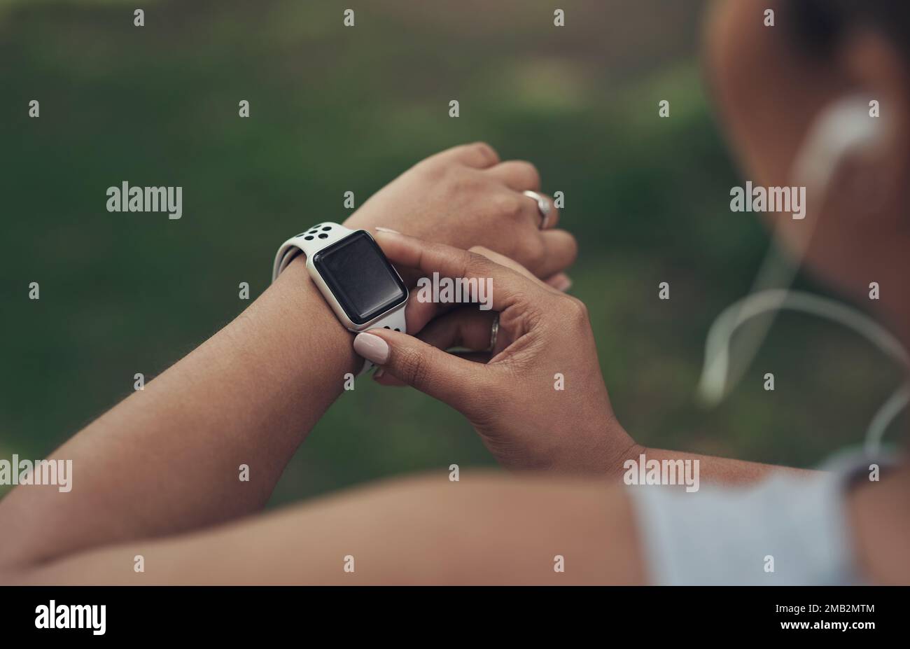 Keeping track of my steps. a woman using her smartwatch during a ...