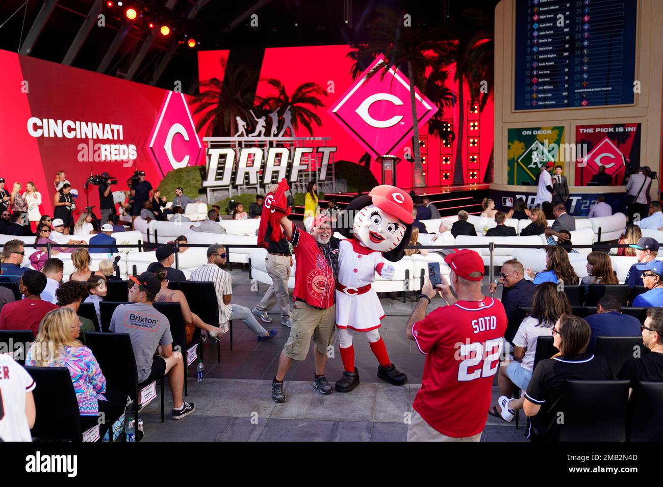 The Cincinnati Reds mascot poses for photos with fans during the 2022 ...