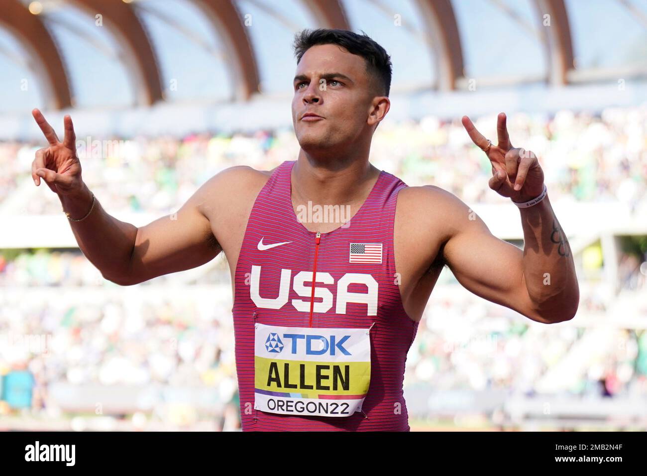 Devon Allen, of the United States, competes in a semi-final heat in the ...