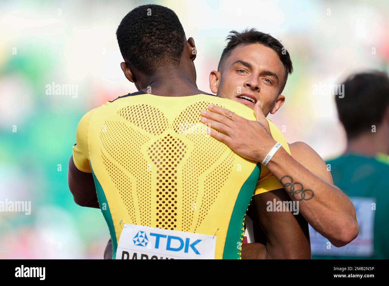 Devon Allen, of the United States, embraces Hansle Parchment, of ...