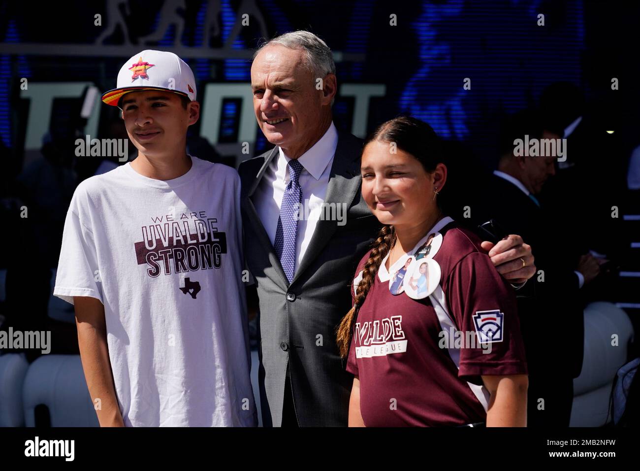 MLB Commissioner Rob Manfred, center, poses for photos with Aidan, left ...