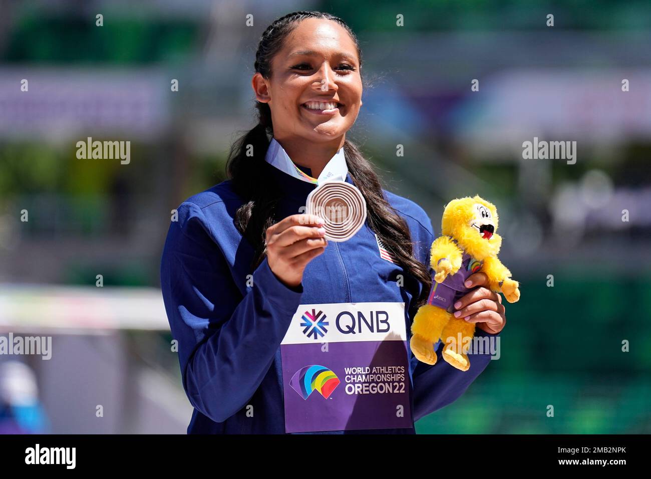 Bronze medalist Janee' Kassanavoid, of the United States, stands on the ...