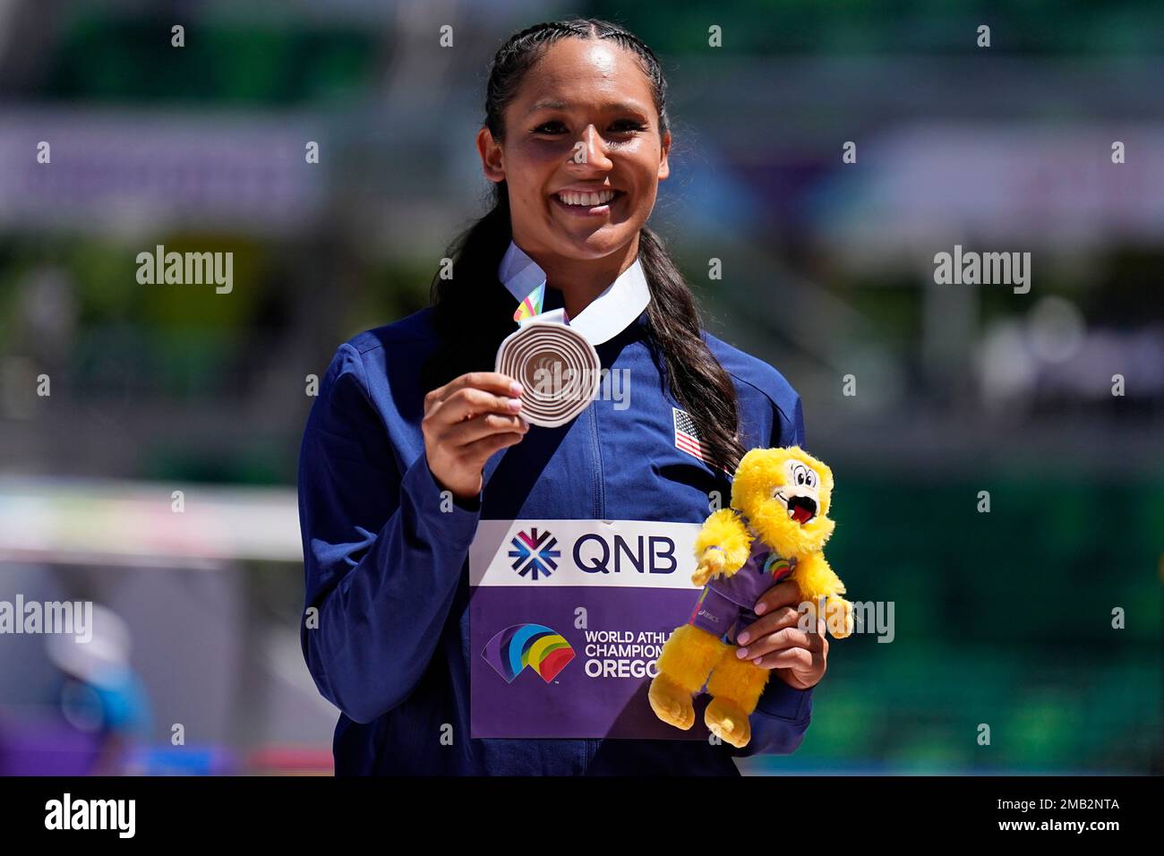 Bronze medalist Janee' Kassanavoid, of the United States, stands on the ...