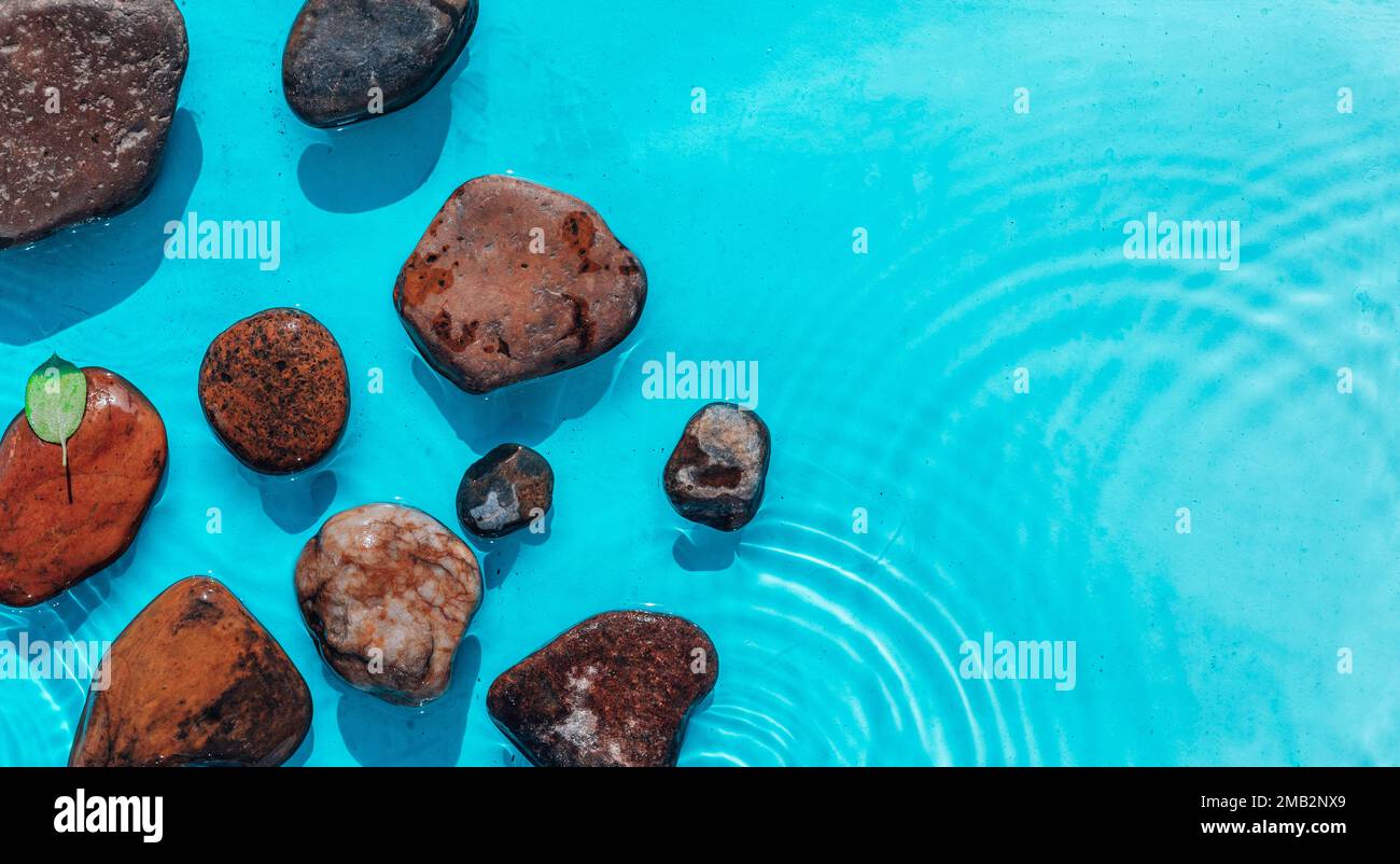 Sea stones in the sea water. Pebbles under water. Top view. Stones In ...