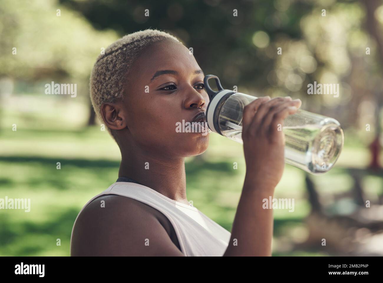 Always replenish the fluids you lose. a young woman taking a break ...