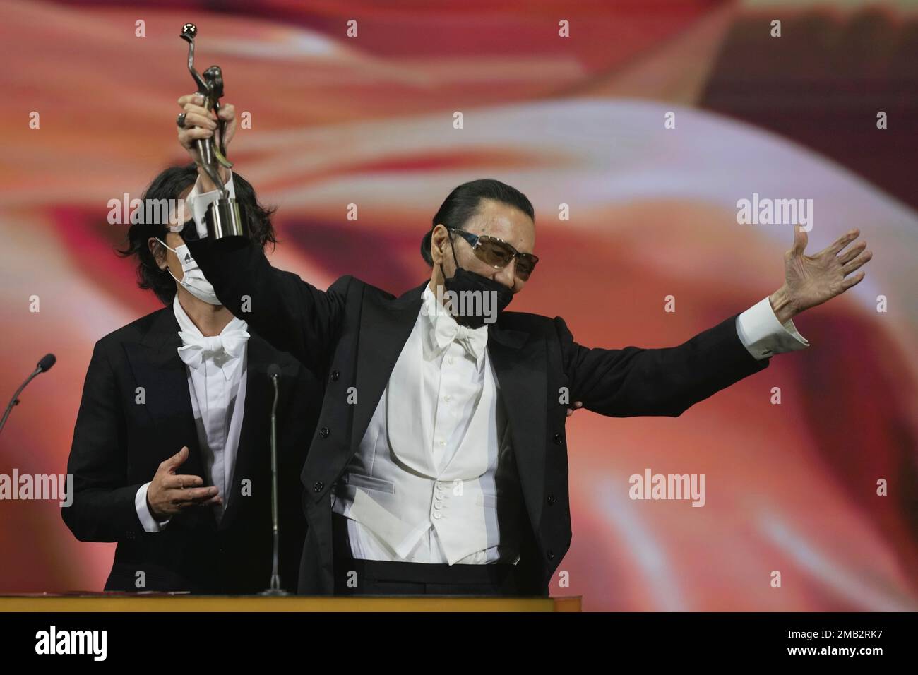 Hong Kong actor Patrick Tse, foreground, gestures after winning the ...