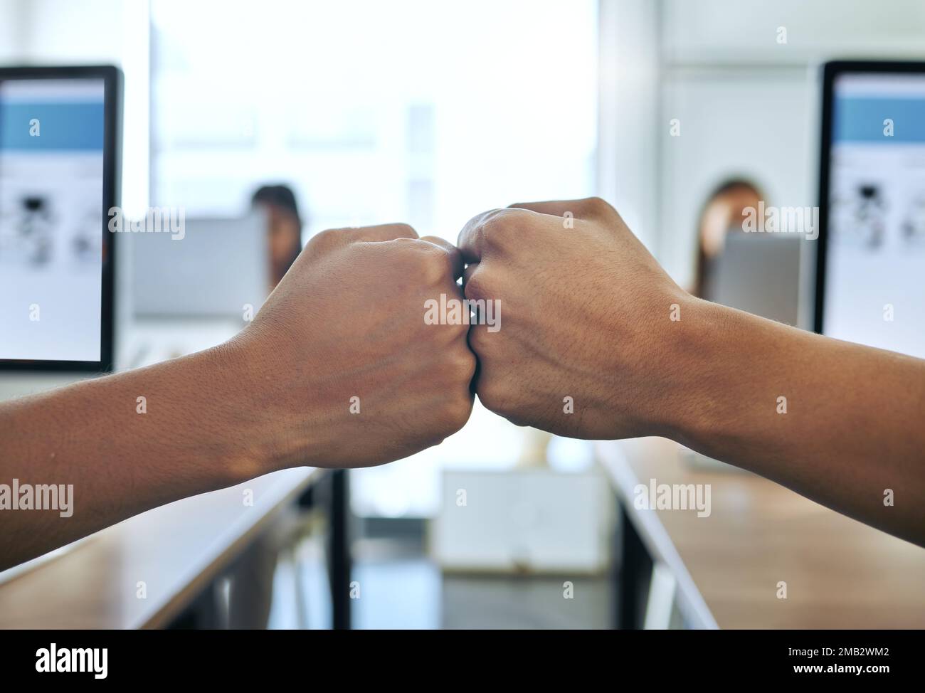 Unite and conquer. two unrecognizable businesspeople sitting together ...
