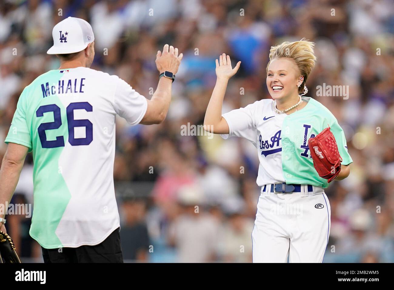 Jojo Siwa, left, high-fives comedian and actor Joel McHale during the ...