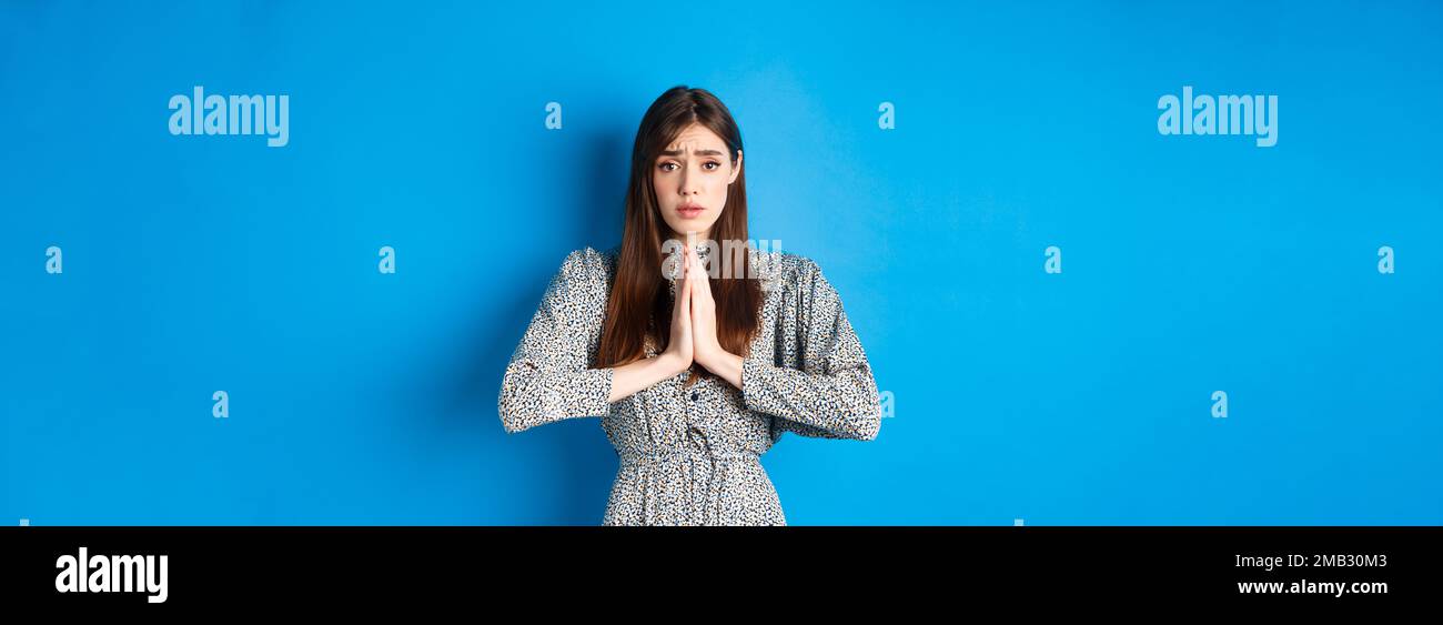 Sad girl asking for help, begging you with troubled face expression ...