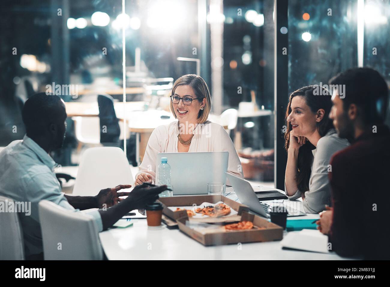 Workshop, late night and marketing team in discussion at meeting with ...