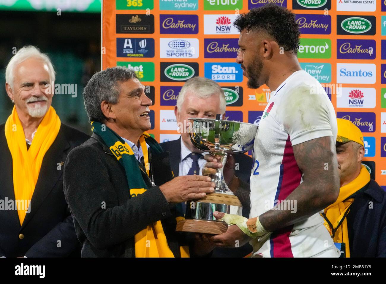 Gary Ella hands the Ella-Mobbs Cup to England captain Courtney Lawes ...