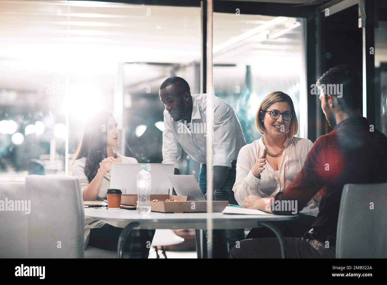 Business, late night help and team at workshop with ideas, laptop and ...