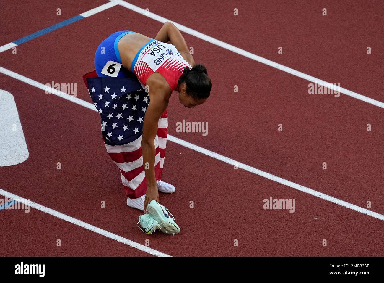 Allyson Felix, of the United States, leaves her shoes on the track ...