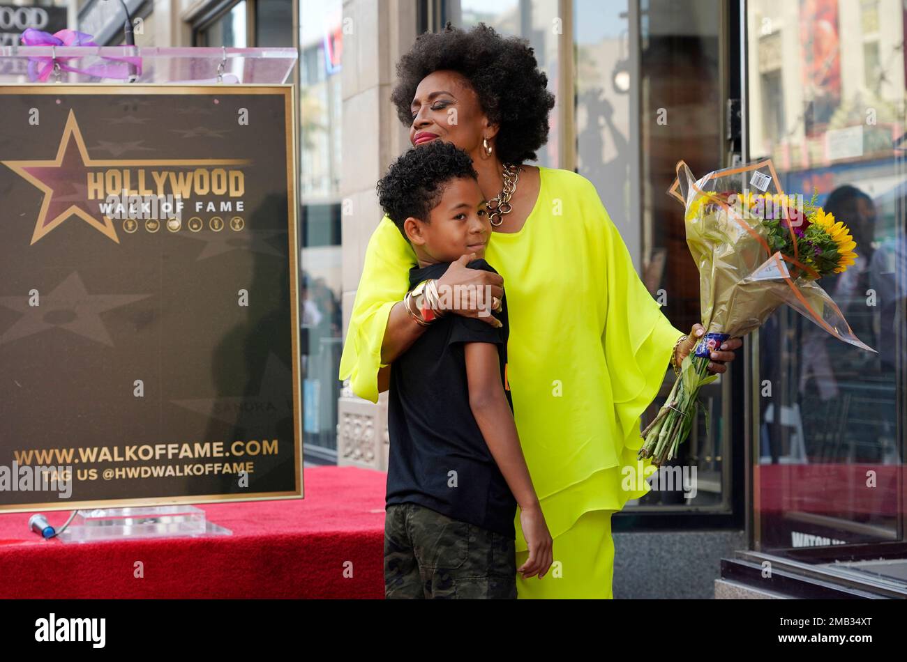Actor Jenifer Lewis accepts a bouquet of flowers from young fan Carter ...