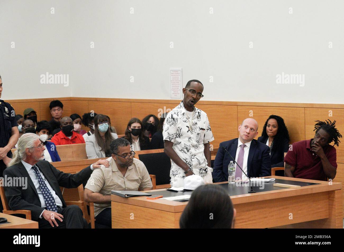 Vincent Ellerbe, center, address the court speaking for himself and ...