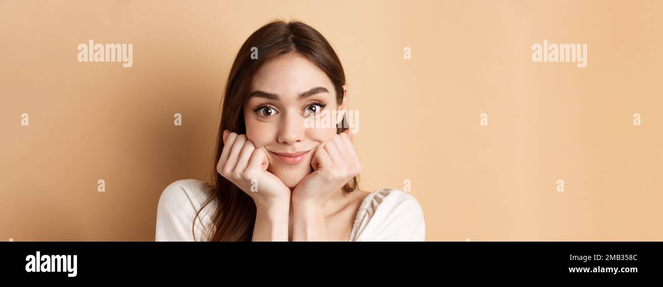 Portrait of intrigued girl listening with interest and excitement, hear ...