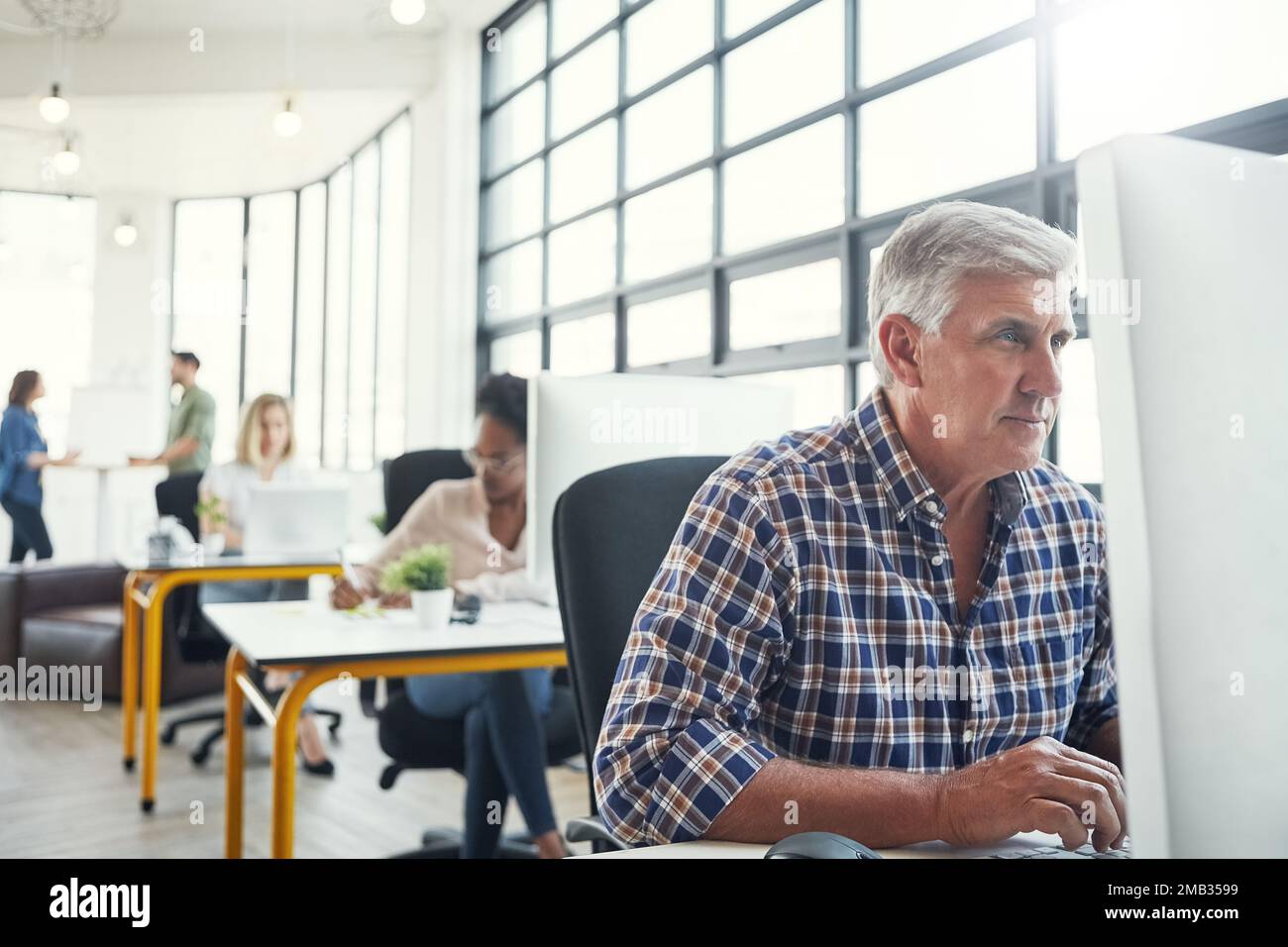 Business, office building and senior man with computer working on ...