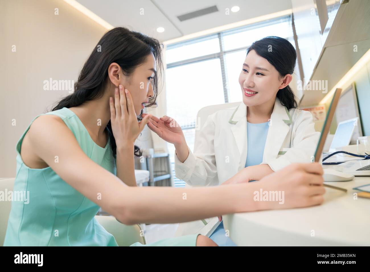 Professional reception young woman Stock Photo - Alamy