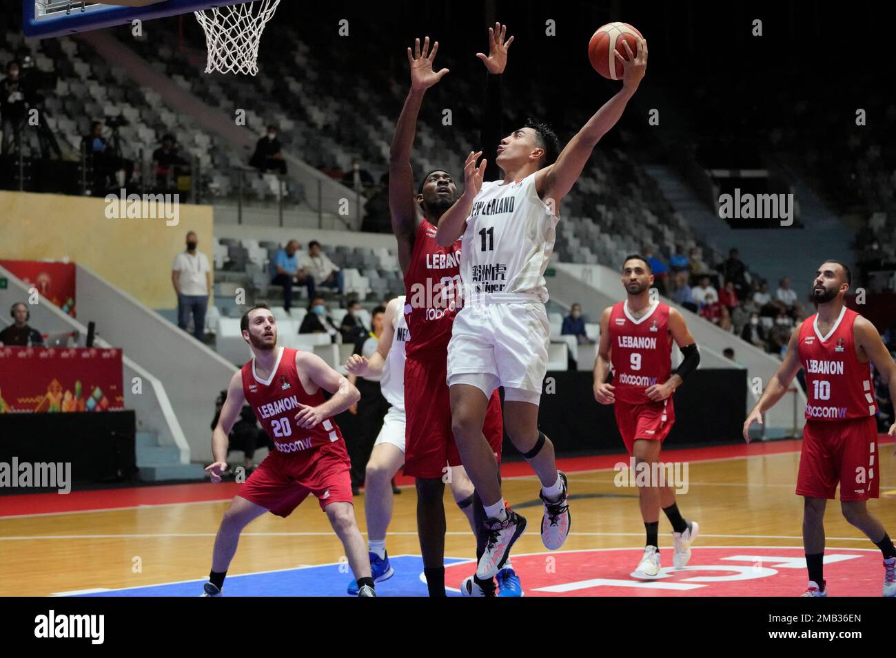 New Zealand's Flynn Cameron, right, shoots against Lebanon's Jonathan ...