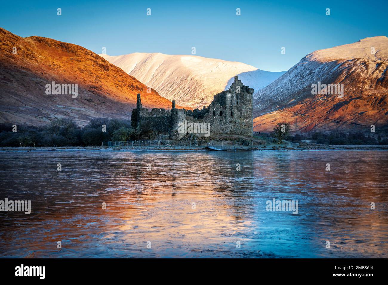 Kilchurn Castle on the banks of a partially frozen Loch Awe, Argyll and ...